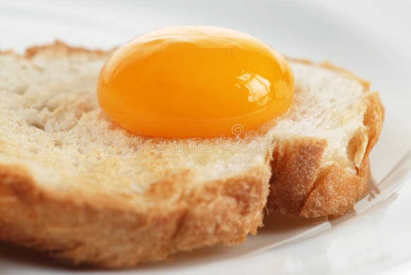 Egg yolk on crusty bread stock image. Image of white, yellow - 6145593