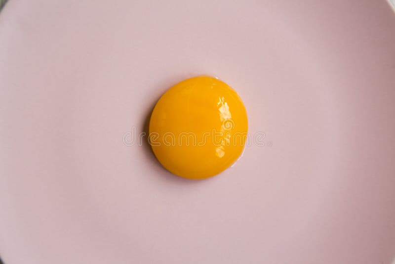 Egg Yolk on a Pink Plate, Top View. Stock Image - Image of pink, liquid ...