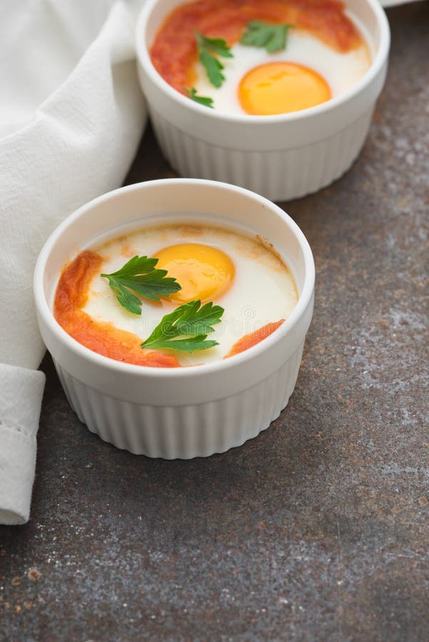 Eggs Baked with Tomatoes and Parsley in the Ramekins Vertical Stock ...
