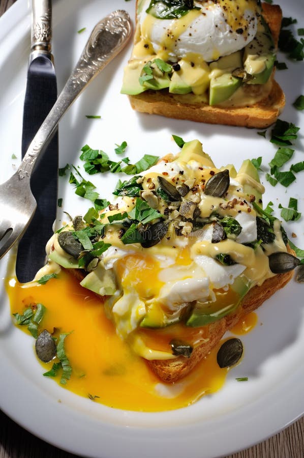 Eggs Benedict with Avocado on Toast Stock Image - Image of elevenses ...