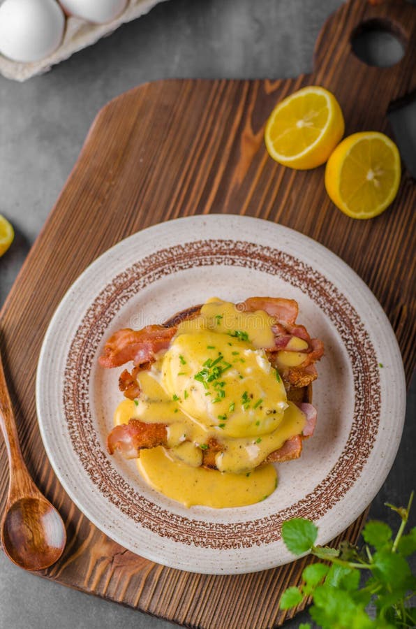 Eggs benedict with bacon stock image. Image of cooking - 91686563