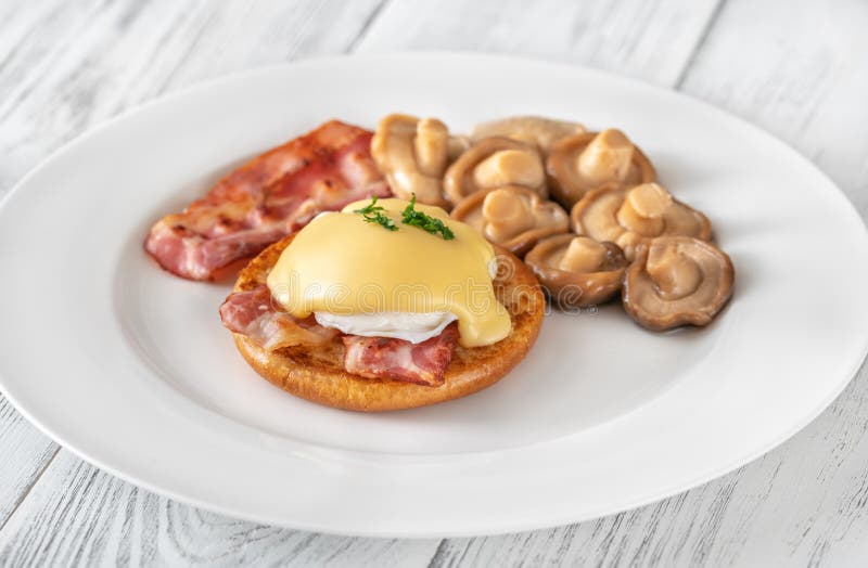 Eggs Benedict with bacon stock image. Image of ingredient - 198419429