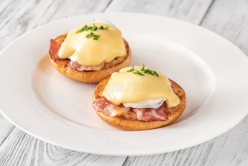 Eggs Benedict with bacon stock photo. Image of dish - 198419444