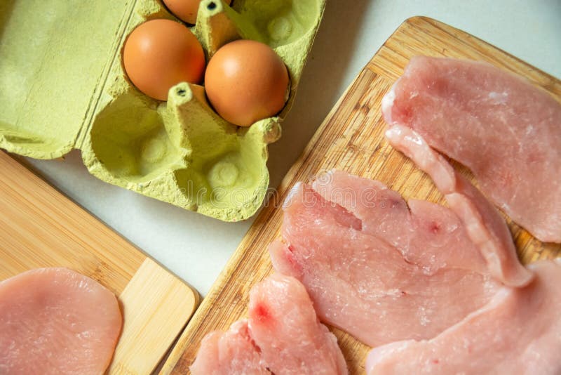 Eggs in a Carton Box and Meat for Chops on the Table Stock Image ...