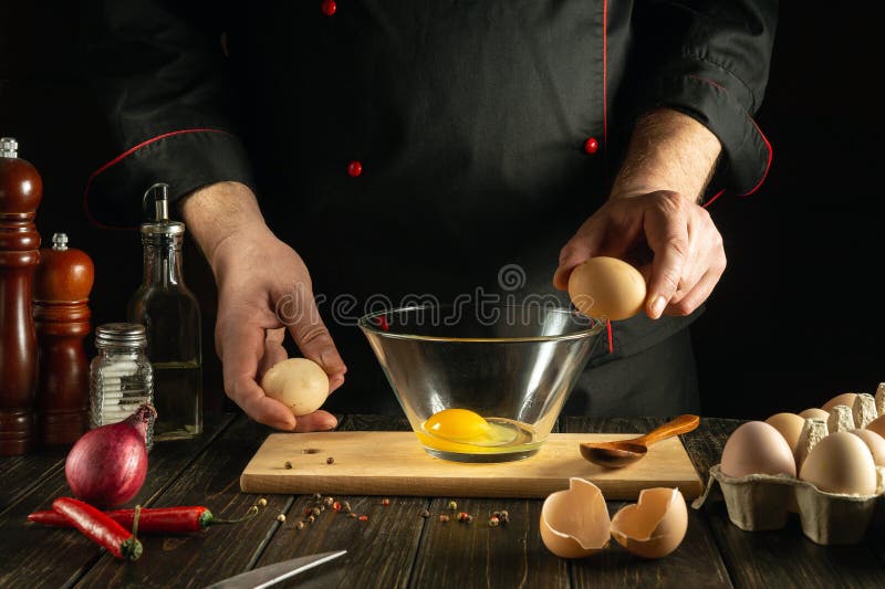 Eggs in the Cook Hands before Breaking into a Bowl. Cooking Scrambled ...