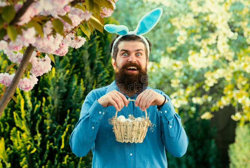 Eggs Hunt. Man in Bunny Ears Holds Easter Egg. Rabbit Man. Man with ...