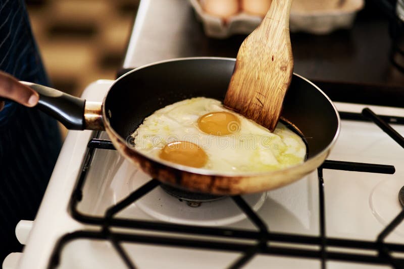 Eggs always Make a Good Breakfast. an Unrecognizable Man Frying Eggs ...