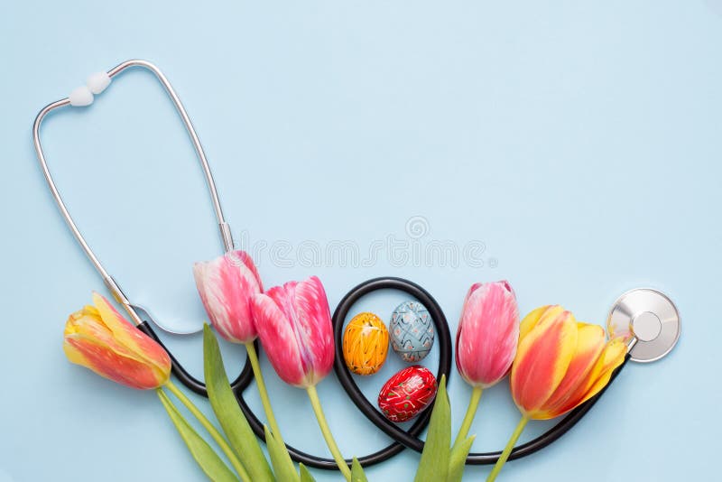 A Stethoscope on Blue Background with a Spring Flowers Stock Image ...