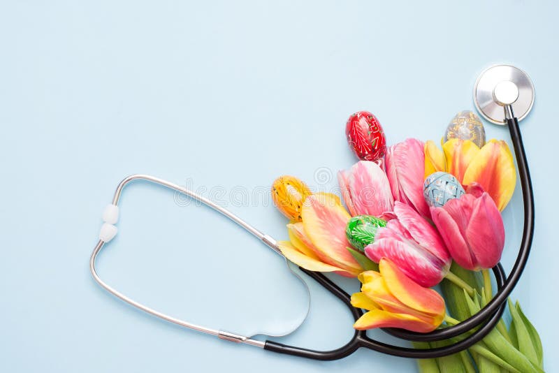 A Stethoscope on Blue Background with a Spring Flowers Stock Image ...