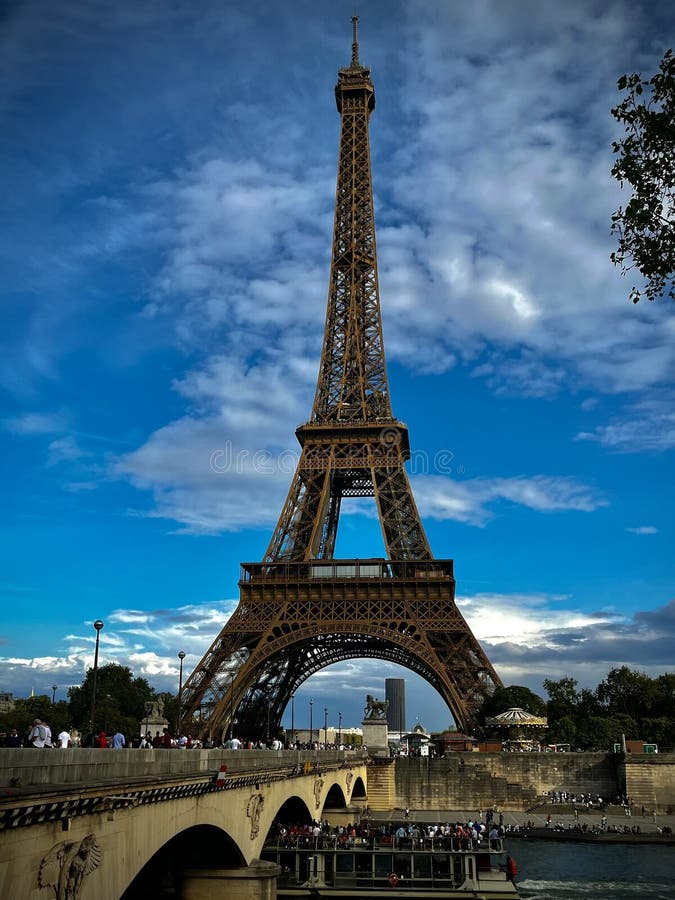 The Eiffel Tower Towering Over a Bridge on a Cloudy Day Editorial ...