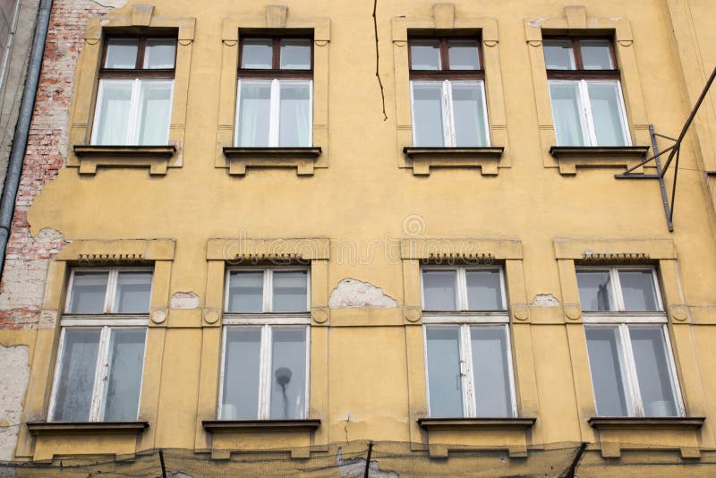Eight Windows on the Facade of the Old Shabby Yellow House Stock Photo ...