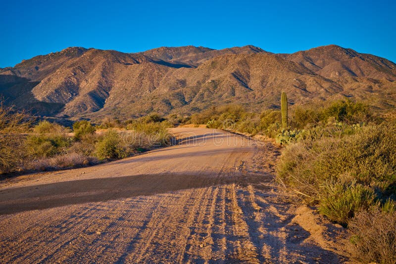 El Oso Road with Warm Morning Light on the Mountains in the Background ...