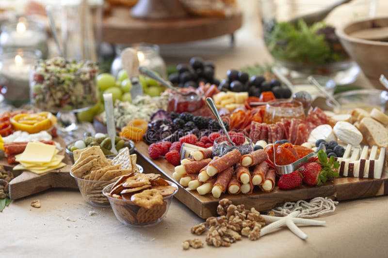 Elaborate Charcuterie Table Set Up with Meats, Bread, Cheese, Nuts, and ...