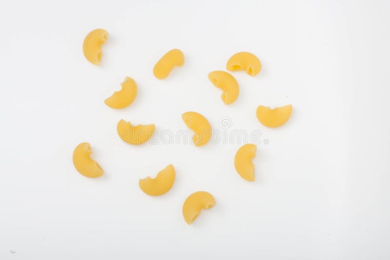 Elbow Shaped Uncooked Pasta Pieces Scattered on Stock Photo - Image of ...