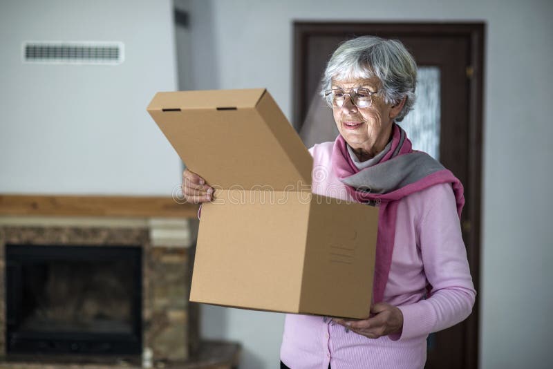 Elder Lady Opening a Delivery Box Stock Photo - Image of indoors ...