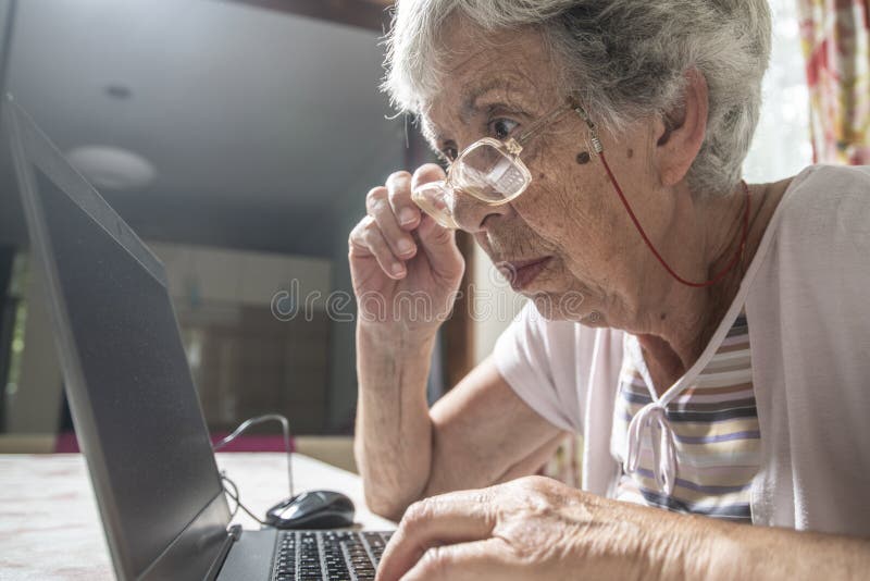 An Elder Lady Using a Laptop Stock Image - Image of human, glasses ...