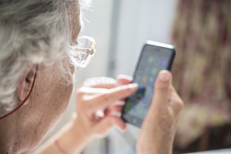 An Elder Lady Using a Smartphone Stock Image - Image of desk, granny ...