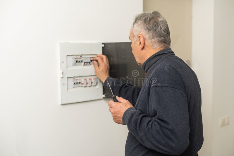 Elder Man Fixing an Electric Meter Stock Image - Image of adult ...