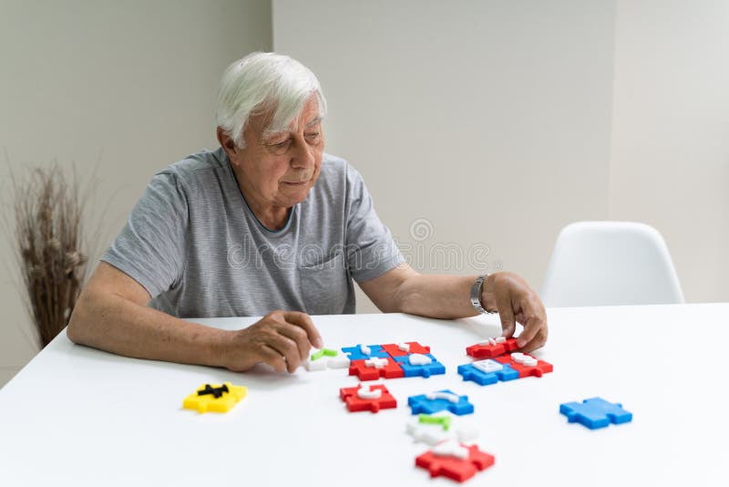 Elder Man Playing Jigsaw Puzzle Stock Photo - Image of elderly ...