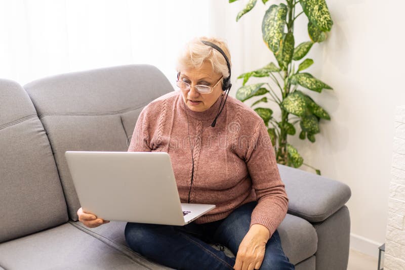 Elder Woman Using a Laptop Computer at Home Stock Photo - Image of ...
