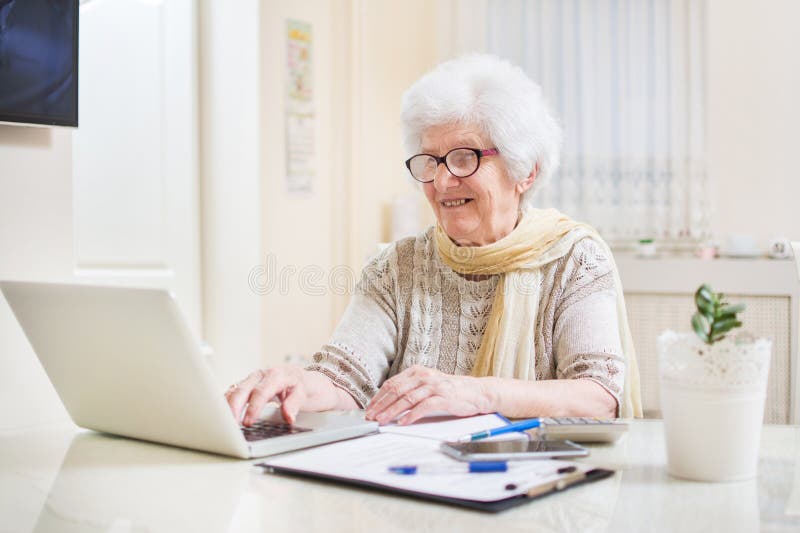 Elder Woman Using a Laptop Computer at Home. Stock Photo - Image of ...
