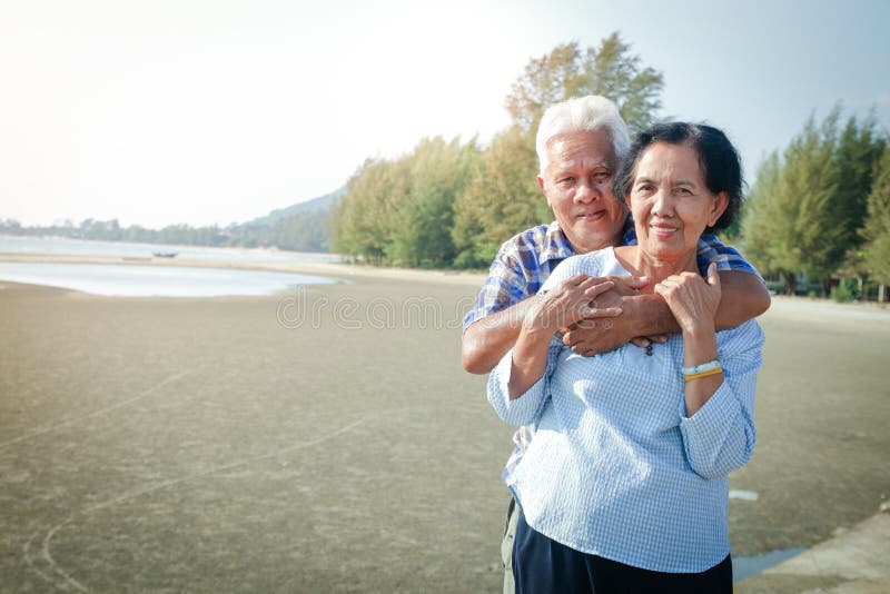 Asian Elderly Couples Sit For Picnics And Relax In The Park Stock