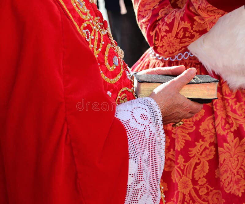 Elderly Bishop with Red Cassock and the Ancient Bible with the Sacred ...