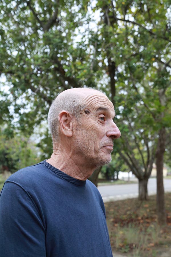 Elderly Man Makes Facial Expression of we Hope Under a Tree in the ...