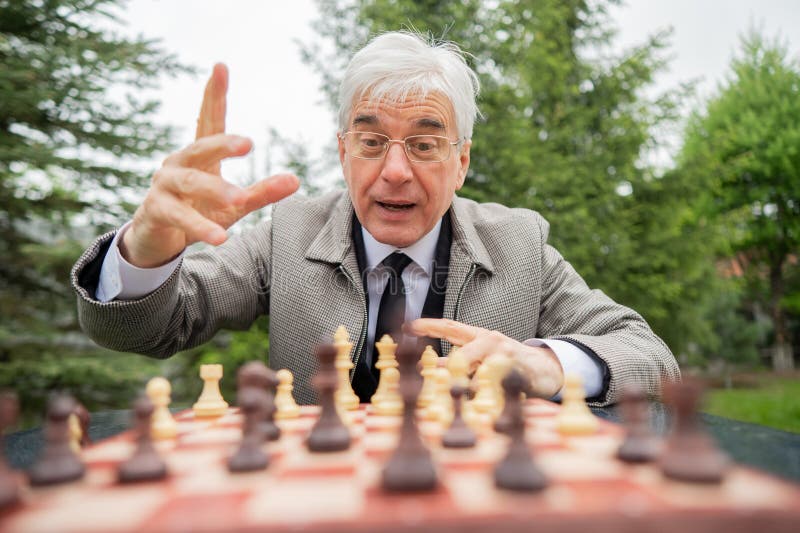 Elderly Caucasian Man Playing Chess Outdoors. Stock Image - Image of ...
