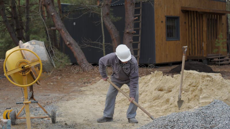 Elderly Construction Worker Mixing Cement Outdoors Stock Footage ...