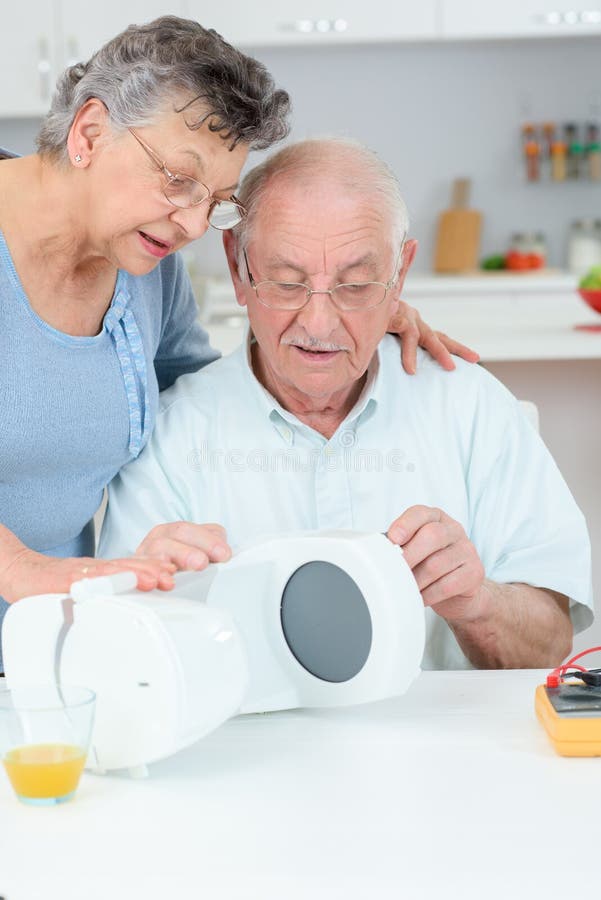 Elderly Couple with Coffee Maker Stock Photo - Image of husband, couple ...