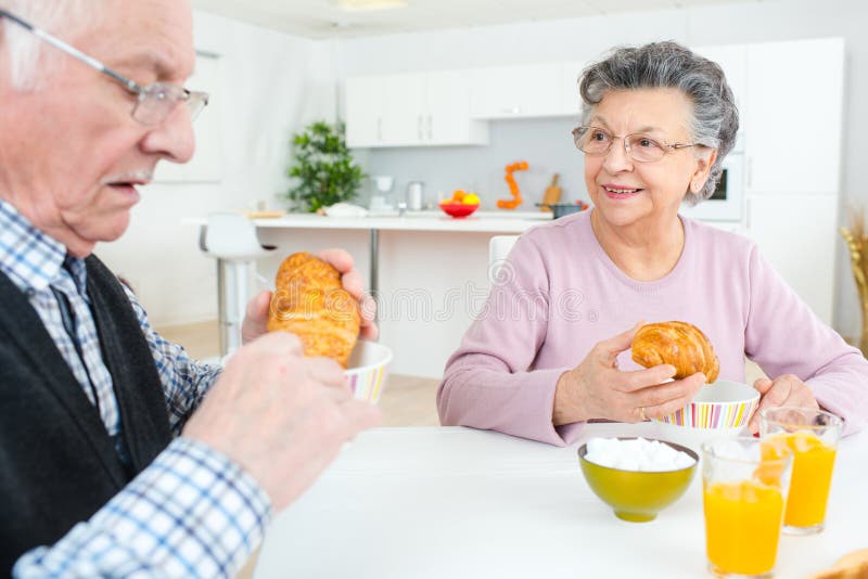 Elderly Couple Eating Continental Breakfast Stock Image - Image of ...