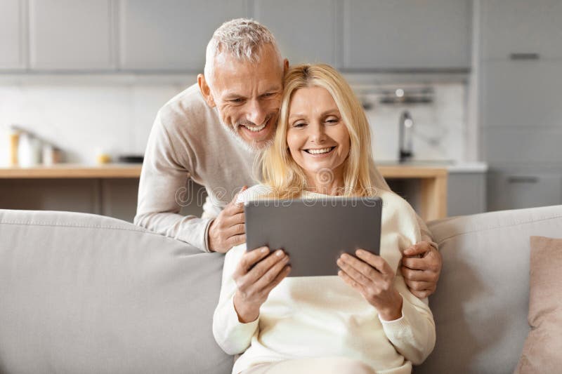 Elderly Couple Engaged with a Digital Tablet Stock Photo - Image of ...