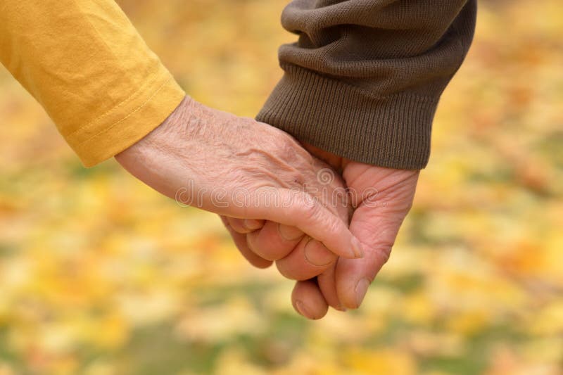 Elderly Couple Holding Hands Stock Photo - Image of hands, outside ...