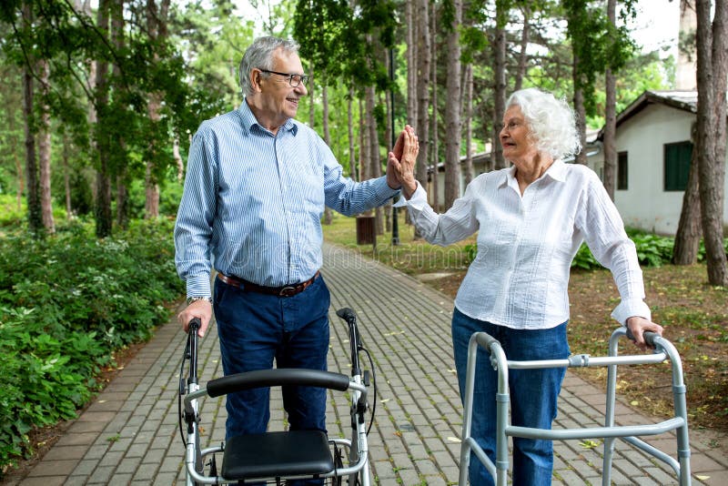 Elderly Couple Holding on To Walking Helper with One Hand Stock Image ...