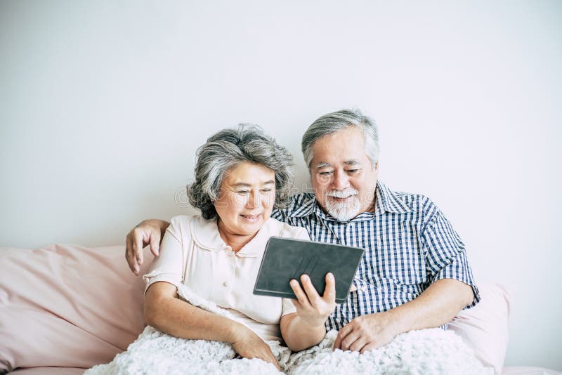 Elderly Couple Tablet Computer Stock Photo - Image of couch, cell ...