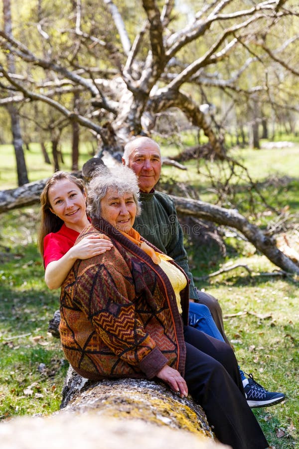 Elderly Couple and Young Caregiver Stock Photo - Image of grandparent ...