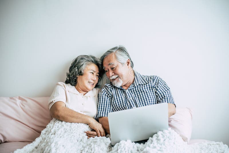 Elderly Couples Using Laptop in Bedroom Stock Photo - Image of bedroom ...