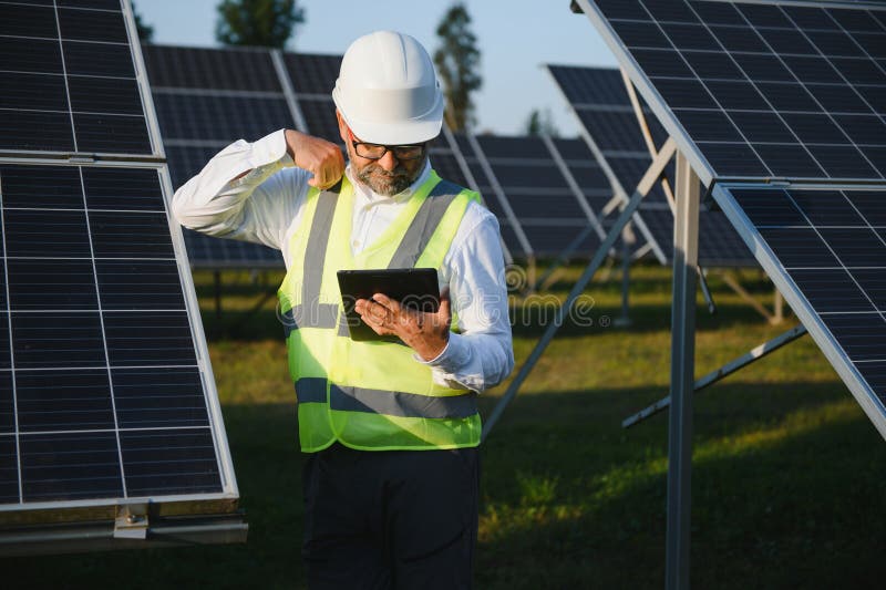Elderly Engineer is Checking with Tablet an Operation of Sun and ...