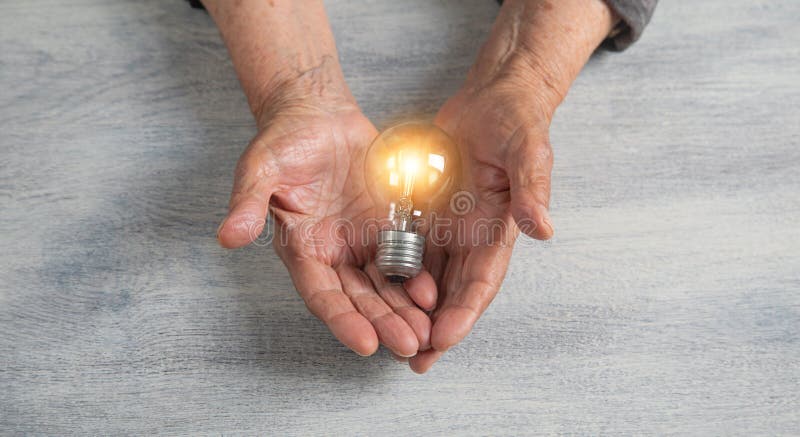 Elderly Female Hand Showing Light Bulb Stock Illustration ...