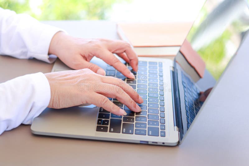 Elderly Hand Using Laptop Computer Typing Text Work in the Garden at ...