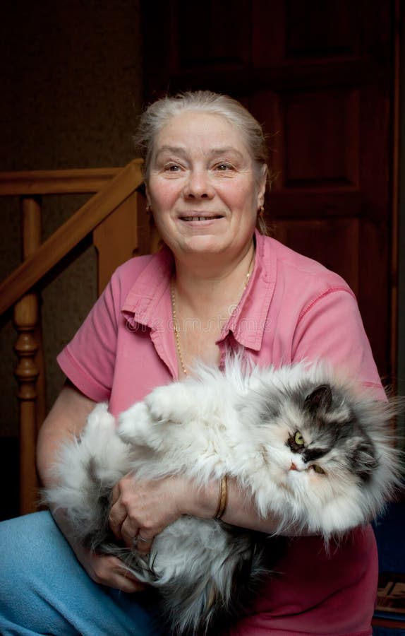 Senior woman holding a cat stock image. Image of blond - 4903601