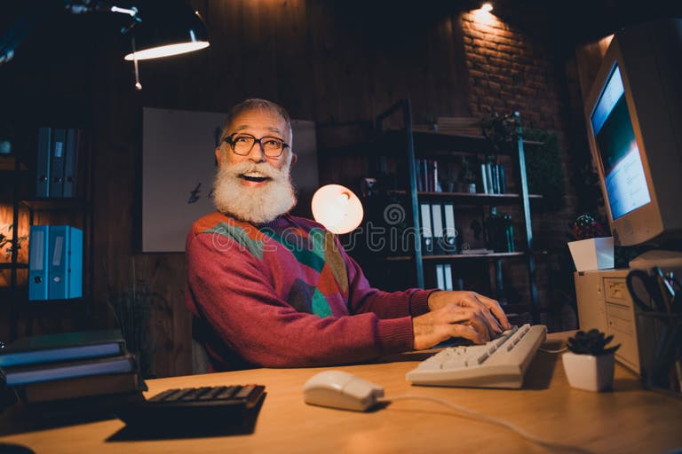 Elderly Male Programmer Working at Home Office in the Evening Using a ...