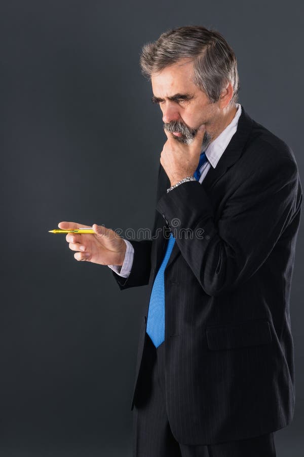 Male Scientist with Pen in Hand Pondering Solution To Problem Stock ...