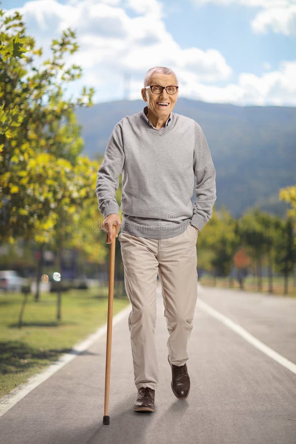 Elderly Man with a Cane Smiling and Walking Stock Image - Image of ...