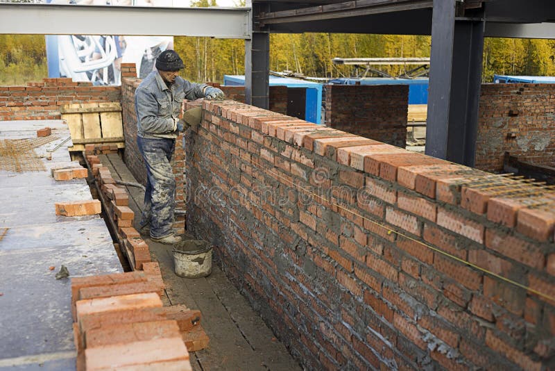 An Elderly Man of Caucasian Appearance Puts a Brick Wall Editorial ...
