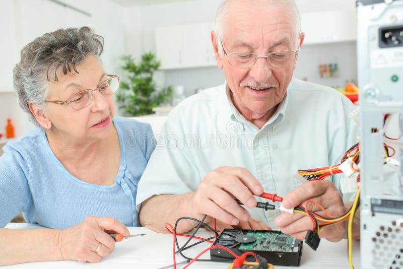 Elderly Man Checking Computer with Multimeter Stock Image - Image of ...