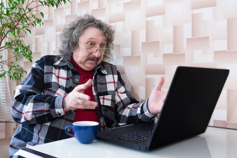 An Elderly Man is Communicating Online on the Laptop Stock Image ...