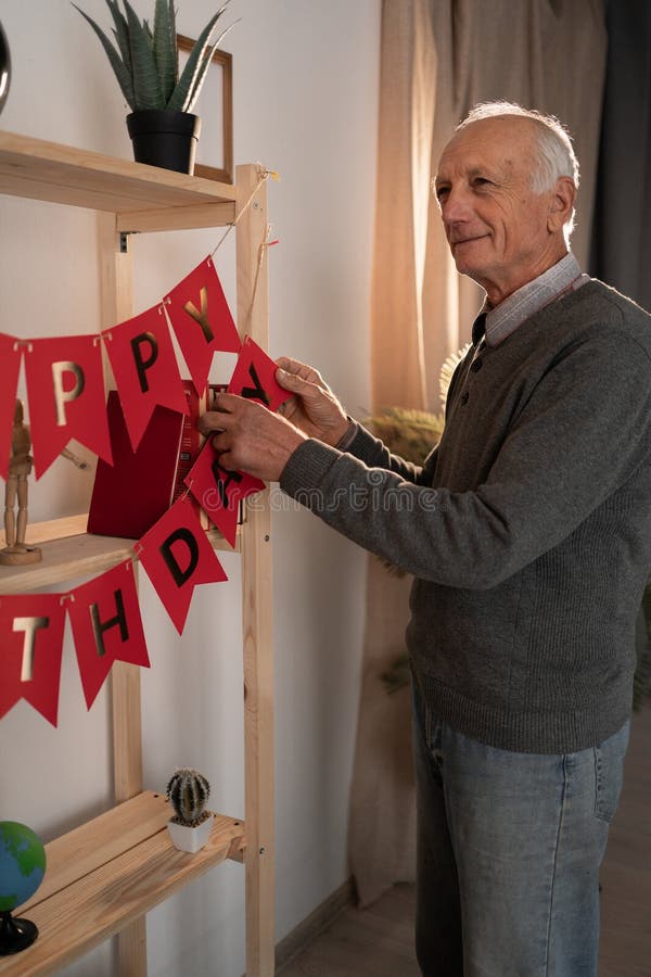 Elderly Man Decorates Room for Birthday, Hangs Banner with ...