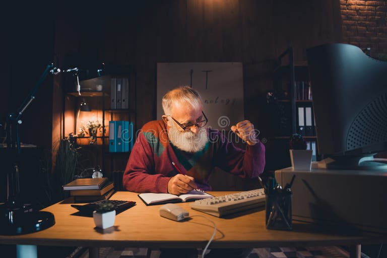 Senior Programmer in Cozy Office Environment Working on Computer Tasks ...